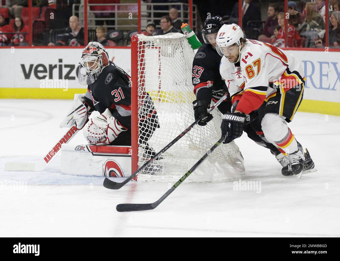 Calgary Flames' Michael Frolik (67) tries to shoot as Carolina ...