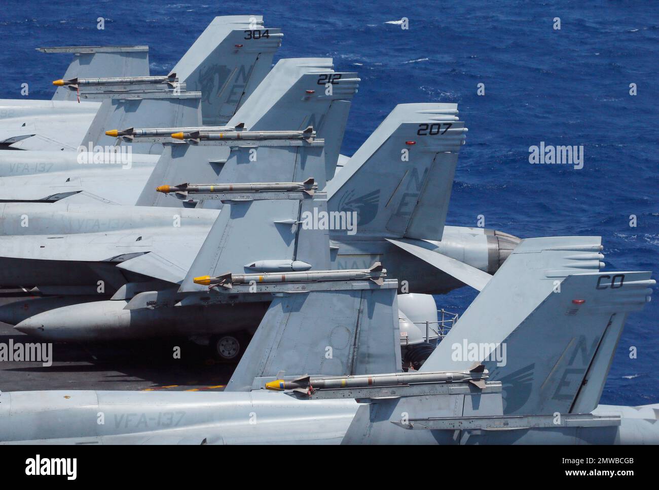 Rockets are mounted on a row of U.S. Navy F18 fighter jets as they are ...