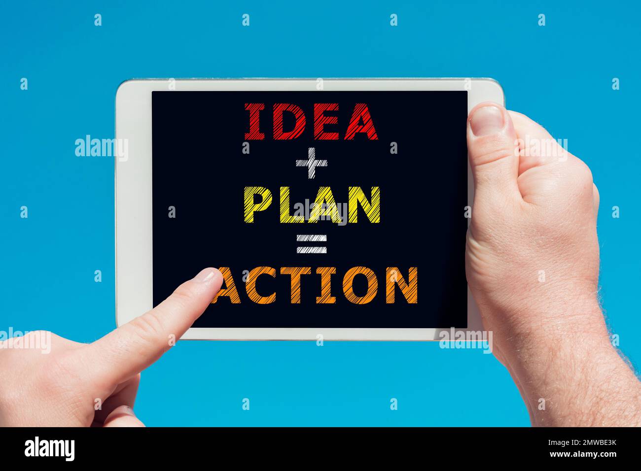 A man holding a tablet device with text "Idea Plan Action" on the ...