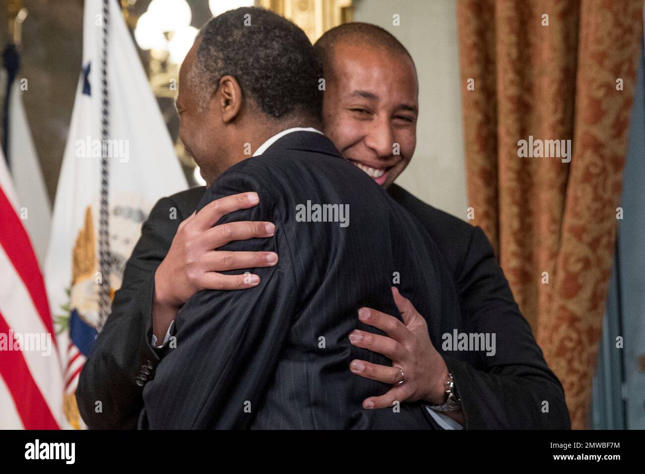 Ben Carson Jr., right, hugs his father Ben Carson after he was sworn in as the Housing and Urban ...