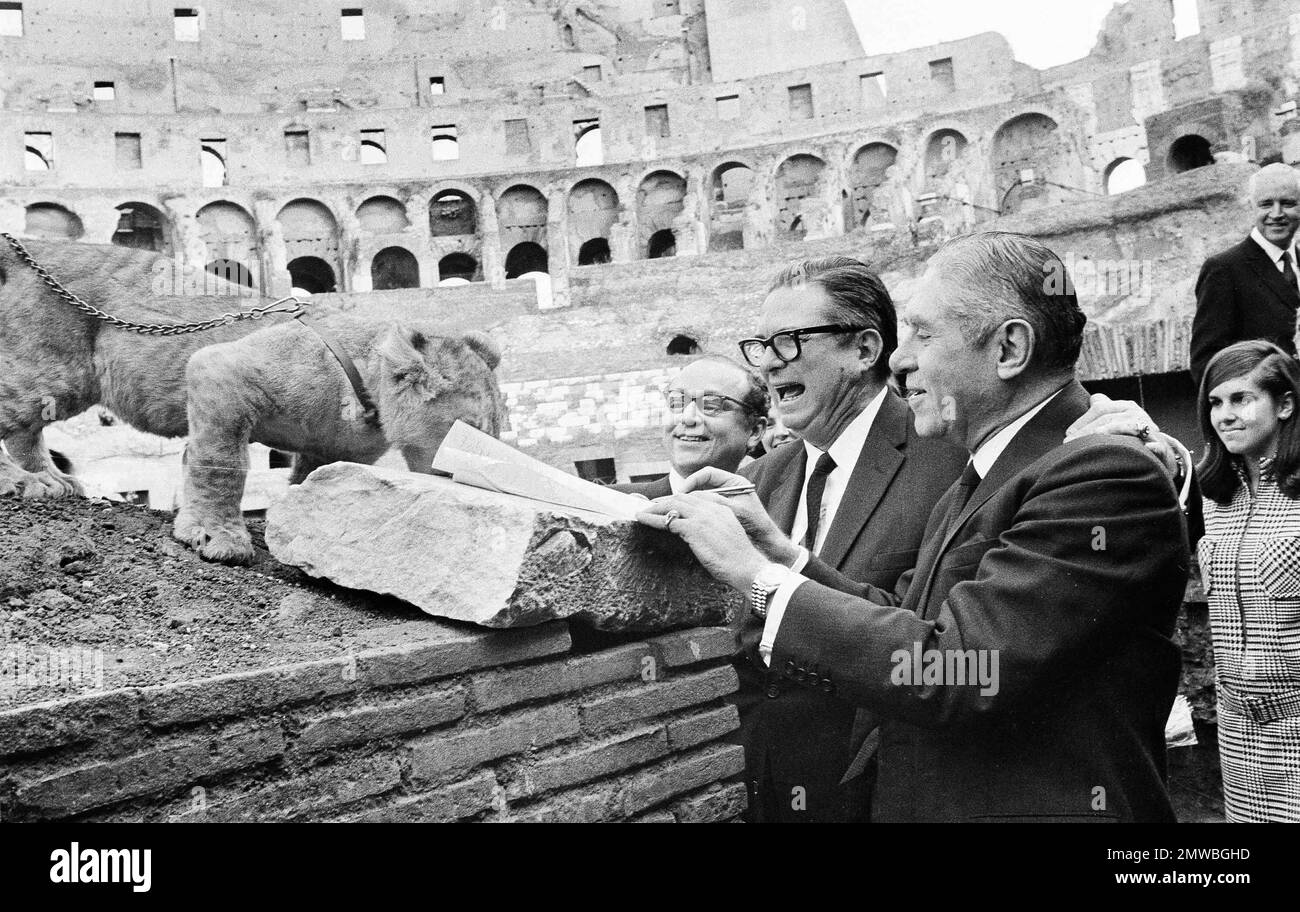A lion cub looks on as John Ringling-North, right, signs an agreement ...