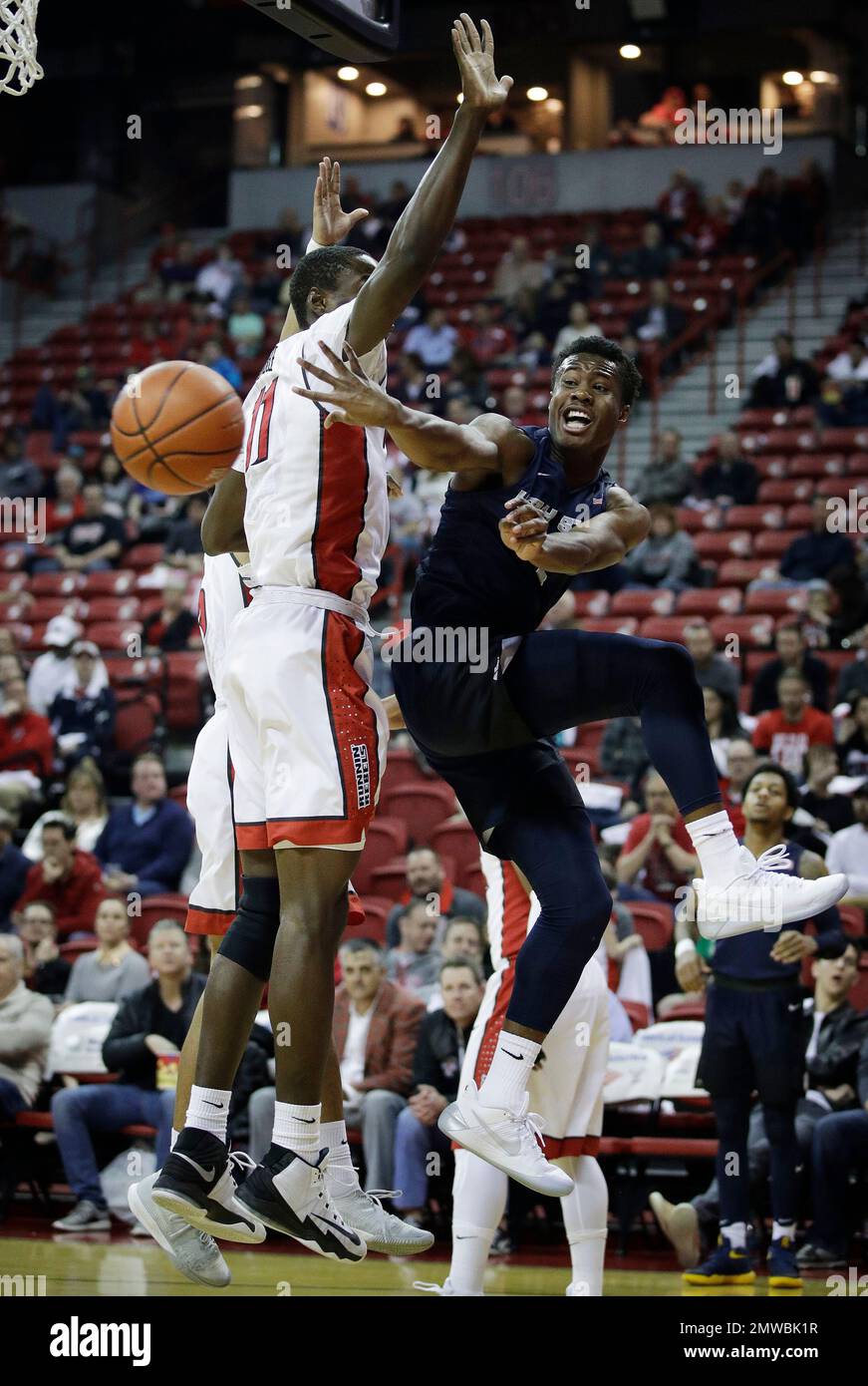 Utah State's Koby McEwen, right, passes around UNLV's Cheickna Dembele ...
