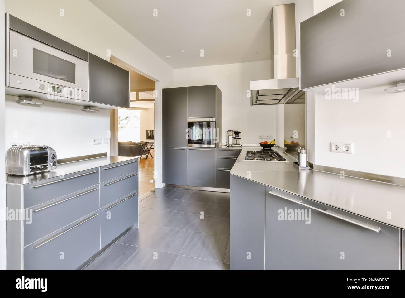 a modern kitchen with grey cabinets and stainless appliances on the ...