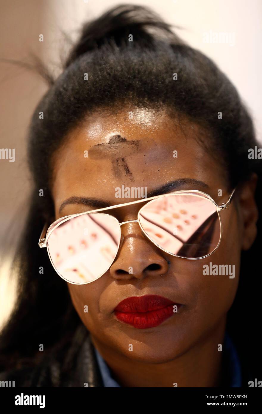Felicia Walker Benson wears Ash Wednesday ashes on her forehead while ...