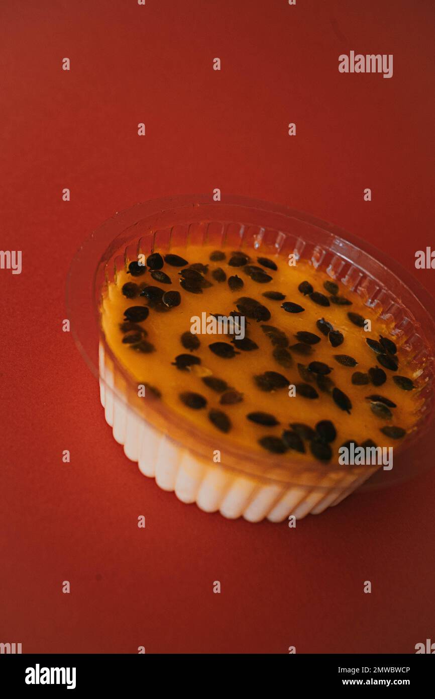 A vertical shot of a plastic bowl of creamy pudding with chocolate ...