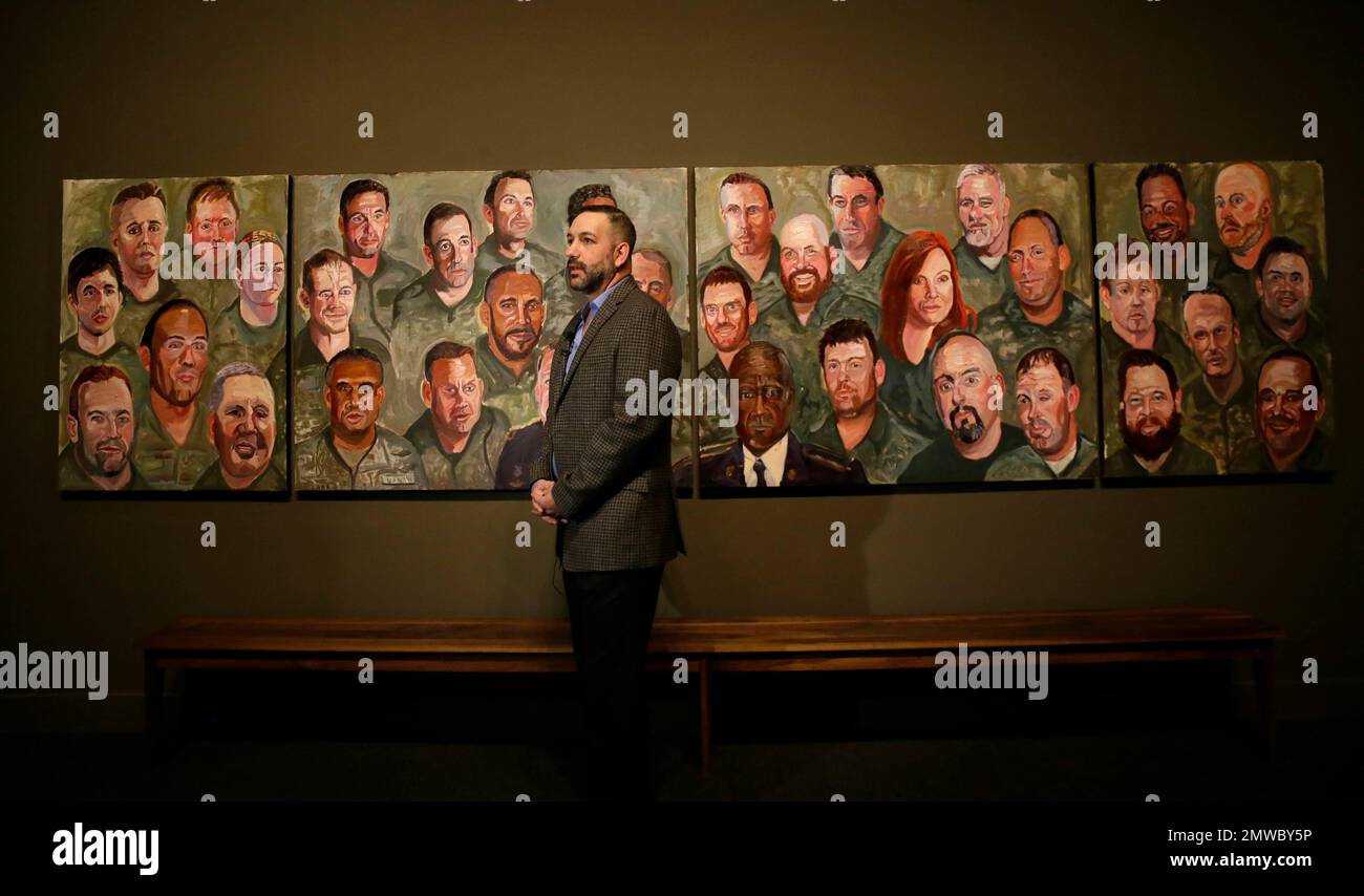 U.S. military veteran Robert Ferrara talks in front of a mural painted ...
