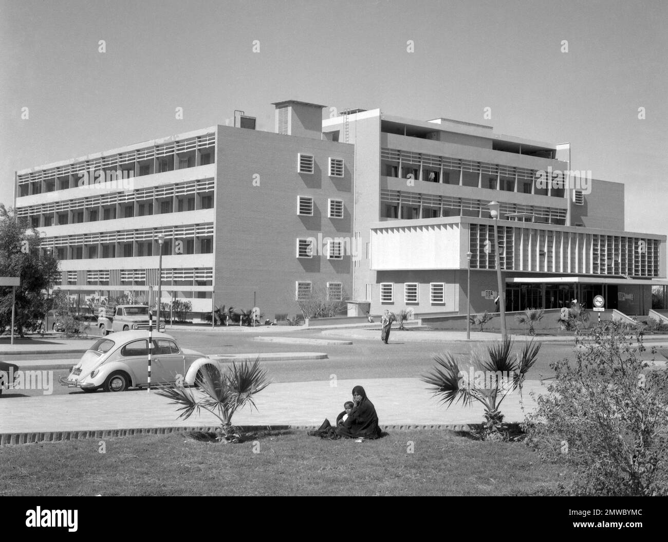 A Kuwaiti woman and a child sit in front of the Assabah Free hospital ...