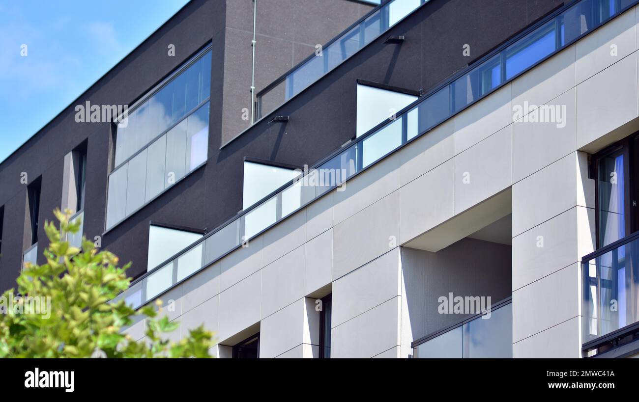 Modern white facade of a residential building with large windows. View ...