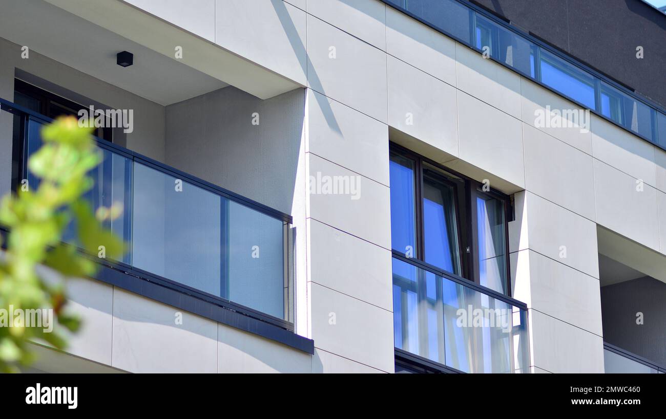 Modern white facade of a residential building with large windows. View ...