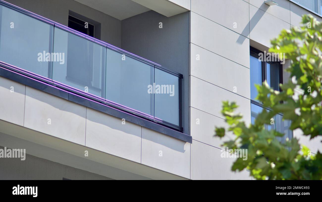 Modern white facade of a residential building with large windows. View ...