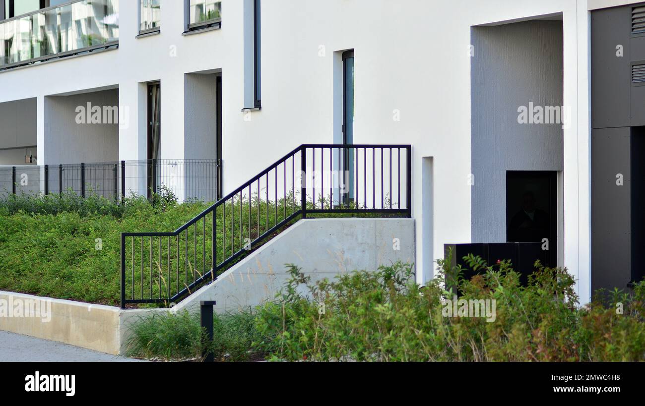 Modern white facade of a residential building with large windows. View ...