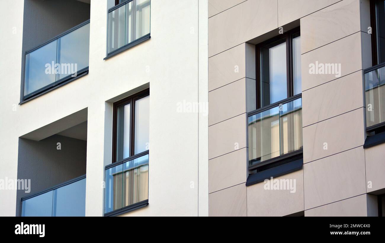 Modern white facade of a residential building with large windows. View ...