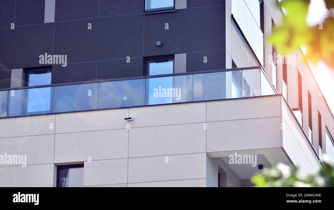 Modern white facade of a residential building with large windows. View ...