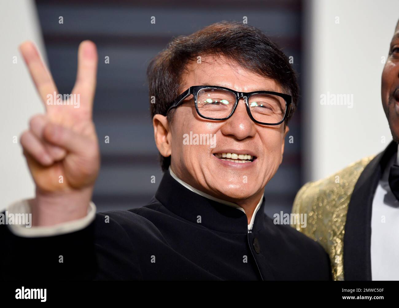 Jackie Chan arrives at the Vanity Fair Oscar Party on Sunday, Feb. 26 ...