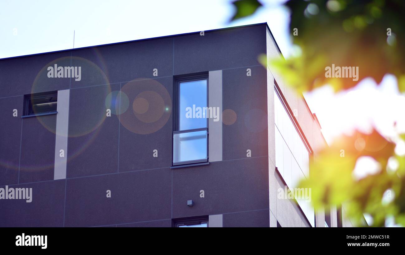 Modern white facade of a residential building with large windows. View ...