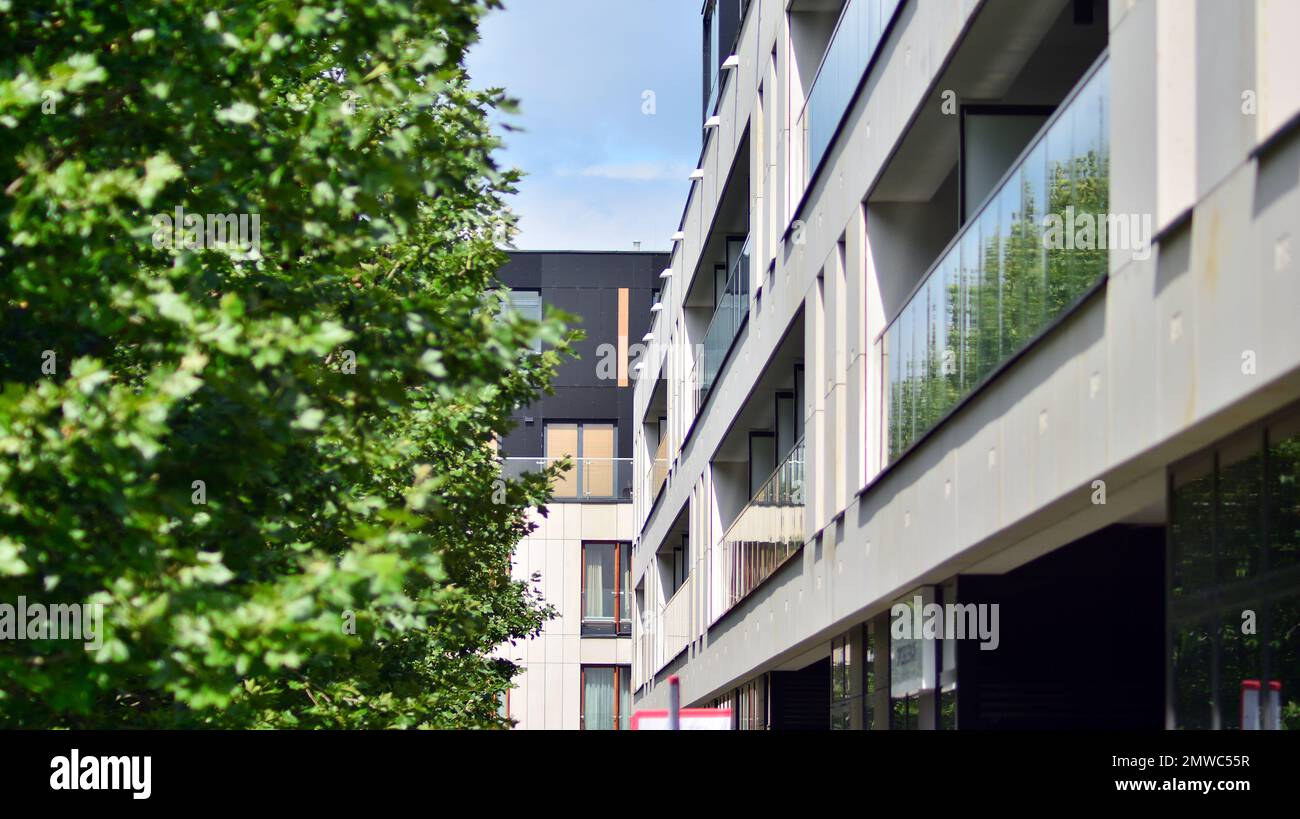 Modern white facade of a residential building with large windows. View ...