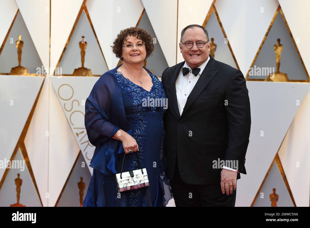 From left, Nancy Lasseter and John Lasseter arrive at the Oscars on ...