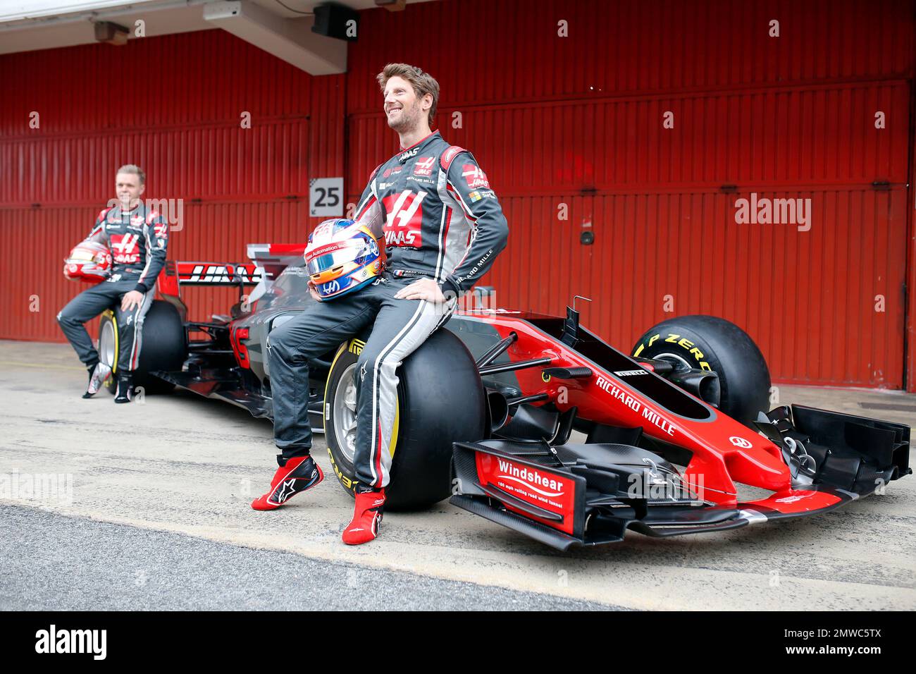 Race drivers Romain Grosjean of France and Kevin Magnussen of Denmark ...