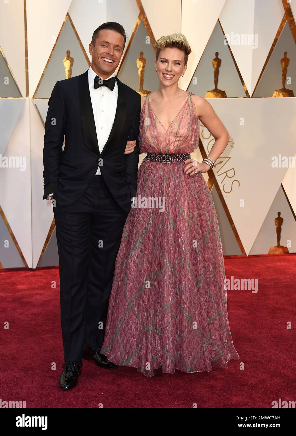 From left, Joe Machota and Scarlett Johansson arrive at the Oscars on ...