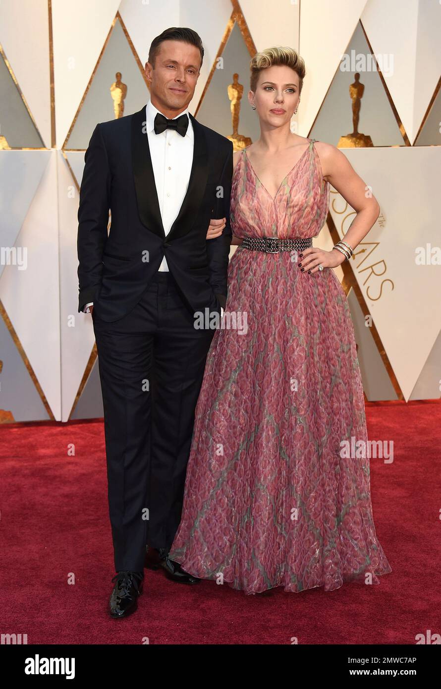 From left, Joe Machota and Scarlett Johansson arrive at the Oscars on ...