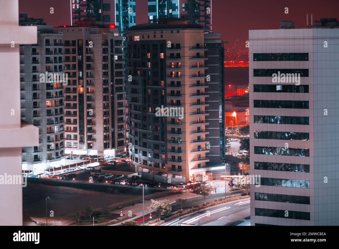 Low-key long-exposure shot of Dubai's modern buildings featuring exposing shiny glass windows on ...