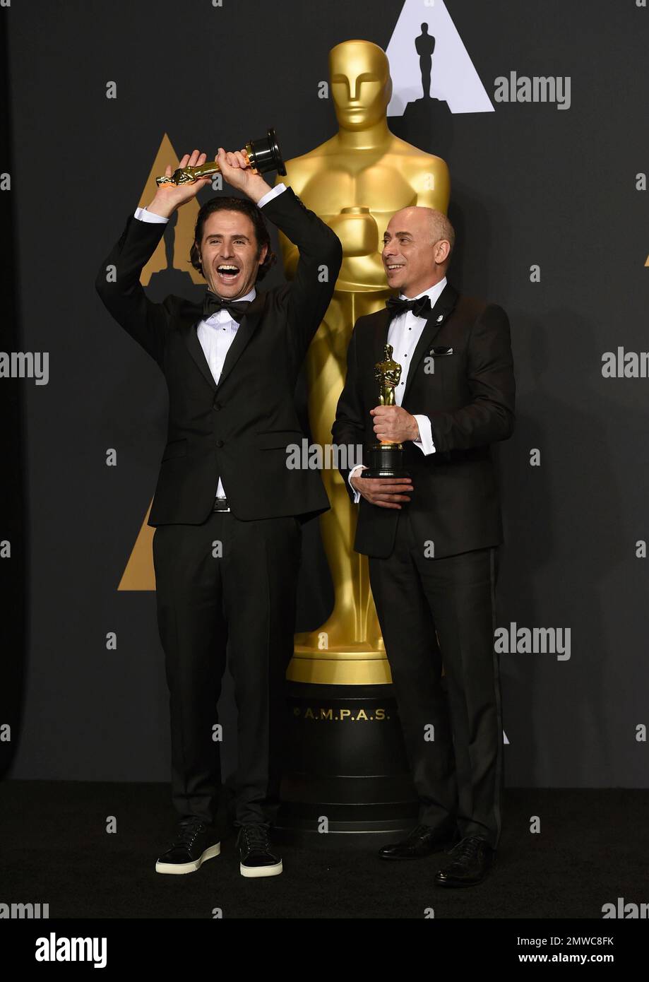 Alan Barillaro, left, and Marc Sondheimer pose in the press room with ...