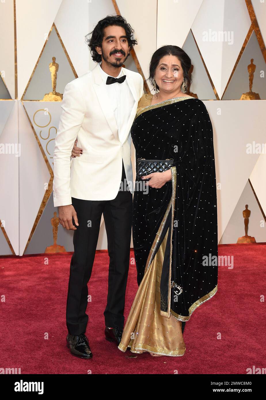 Dev Patel and his mother, Anita Patel, arrive at the Oscars on Sunday ...