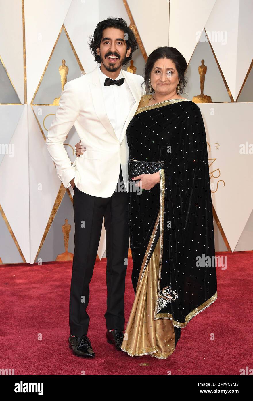 Dev Patel and his mother, Anita Patel, arrive at the Oscars on Sunday ...