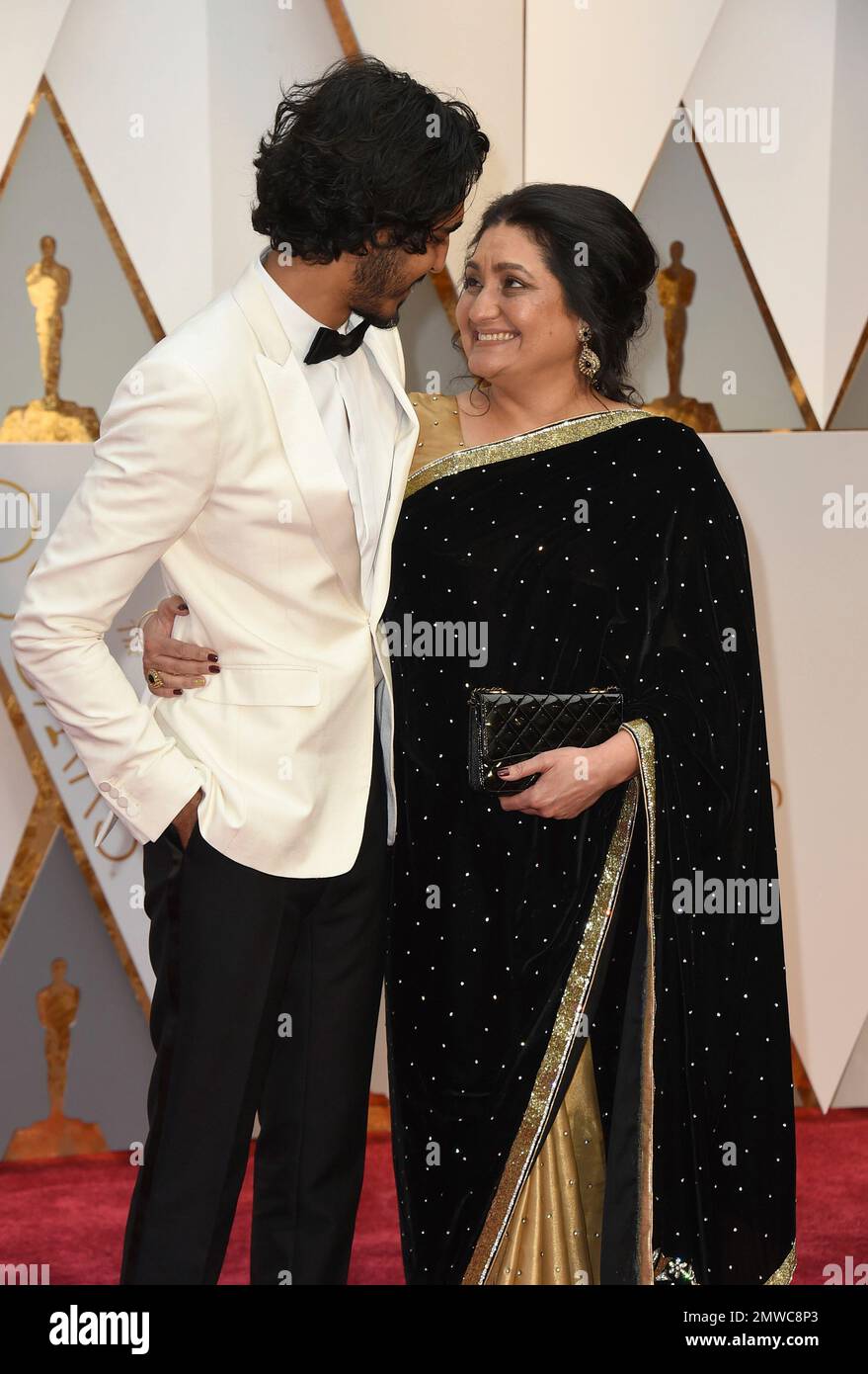 Dev Patel and his mother, Anita Patel, arrive at the Oscars on Sunday ...