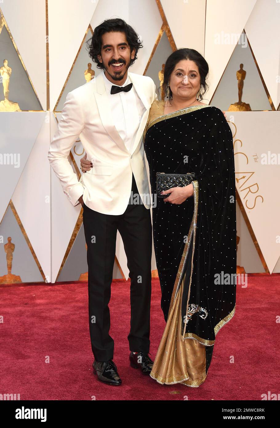 Dev Patel and his mother, Anita Patel, arrive at the Oscars on Sunday ...