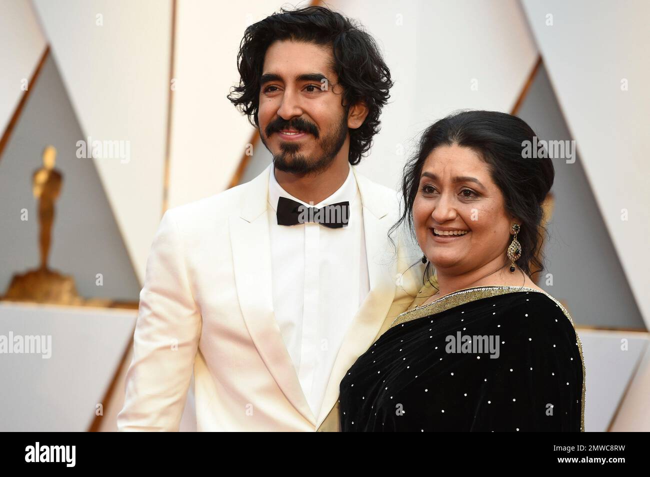Dev Patel and his mother, Anita Patel, arrive at the Oscars on Sunday ...