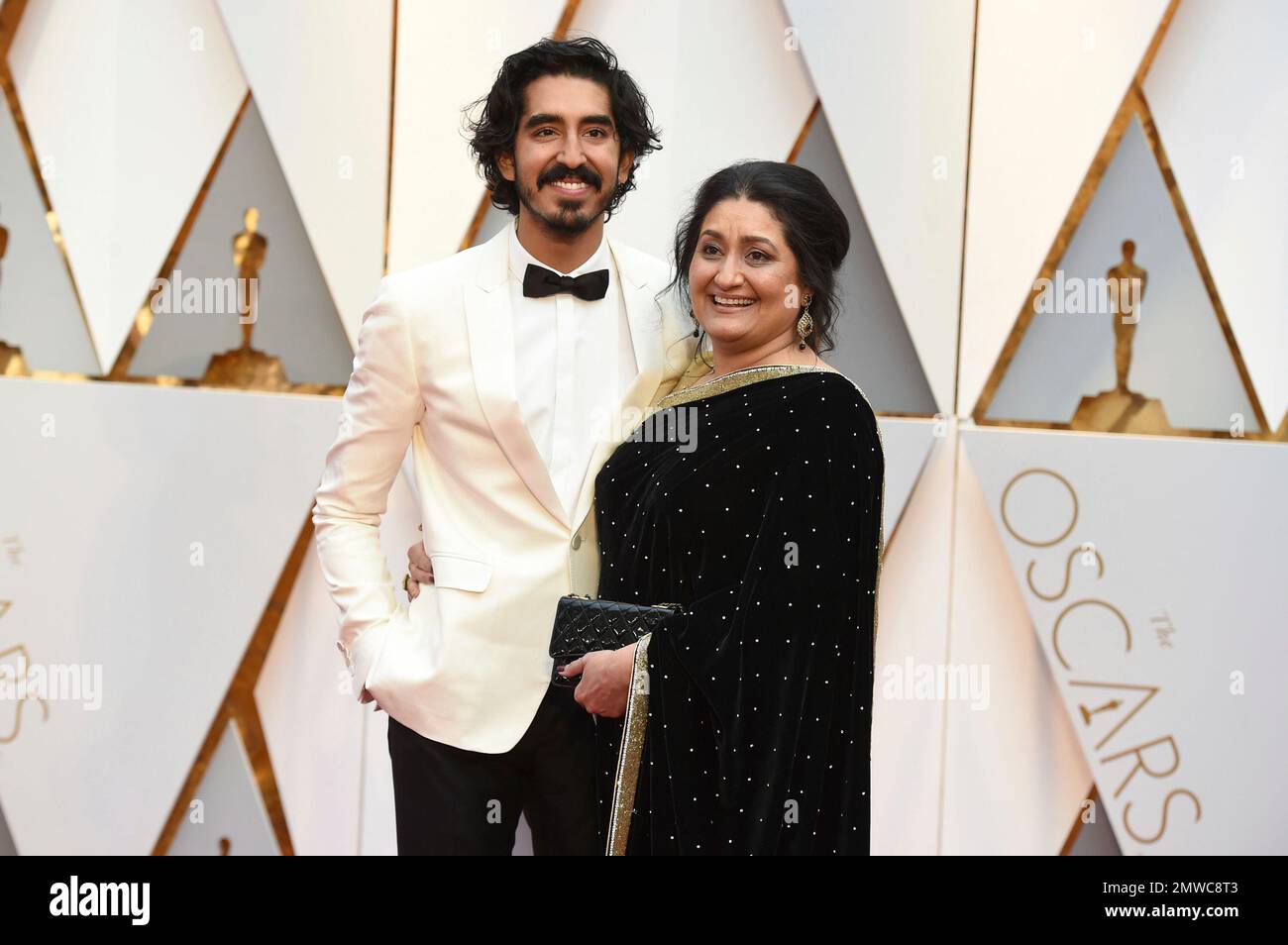 Dev Patel and his mother, Anita Patel, arrive at the Oscars on Sunday ...