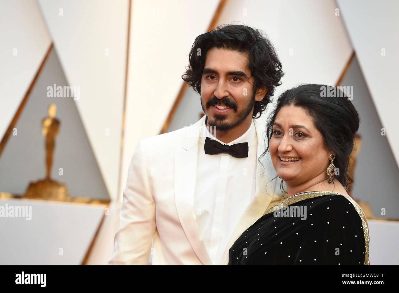 Dev Patel and his mother, Anita Patel, arrive at the Oscars on Sunday ...