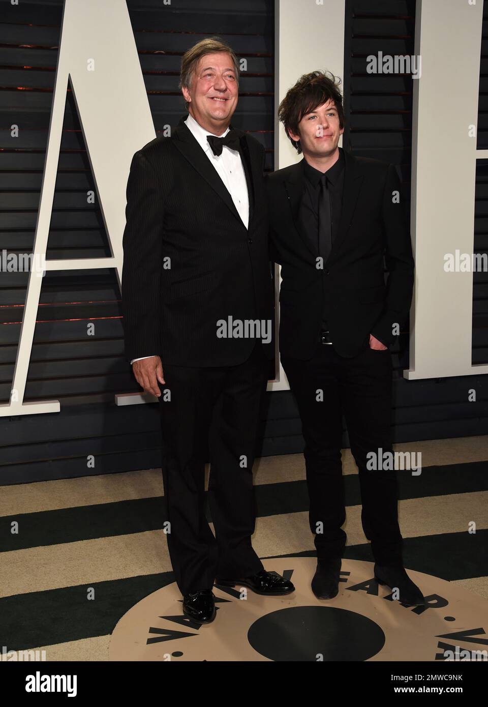 Stephen Fry, left, and Elliott Spencer arrive at the Vanity Fair Oscar ...