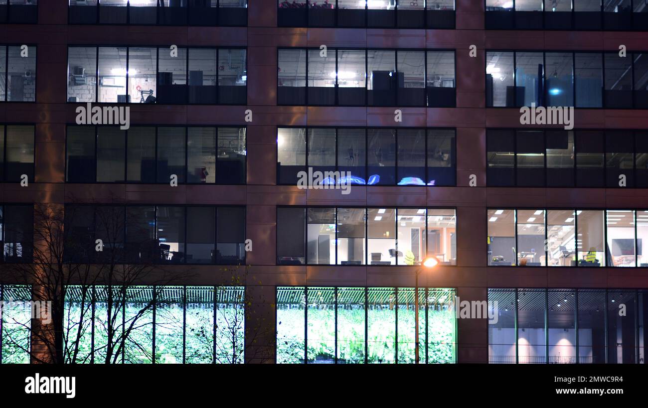 Corporate building at night - business concept. Glass wall office ...