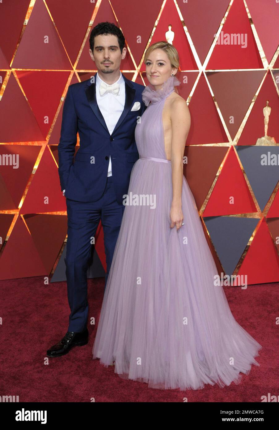 Damien Chazelle, left, and Olivia Hamilton arrive at the Oscars on ...