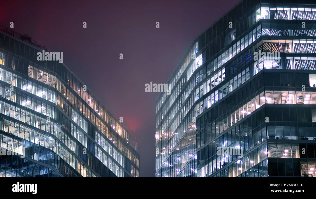 Corporate building at night - business concept. Glass wall office ...