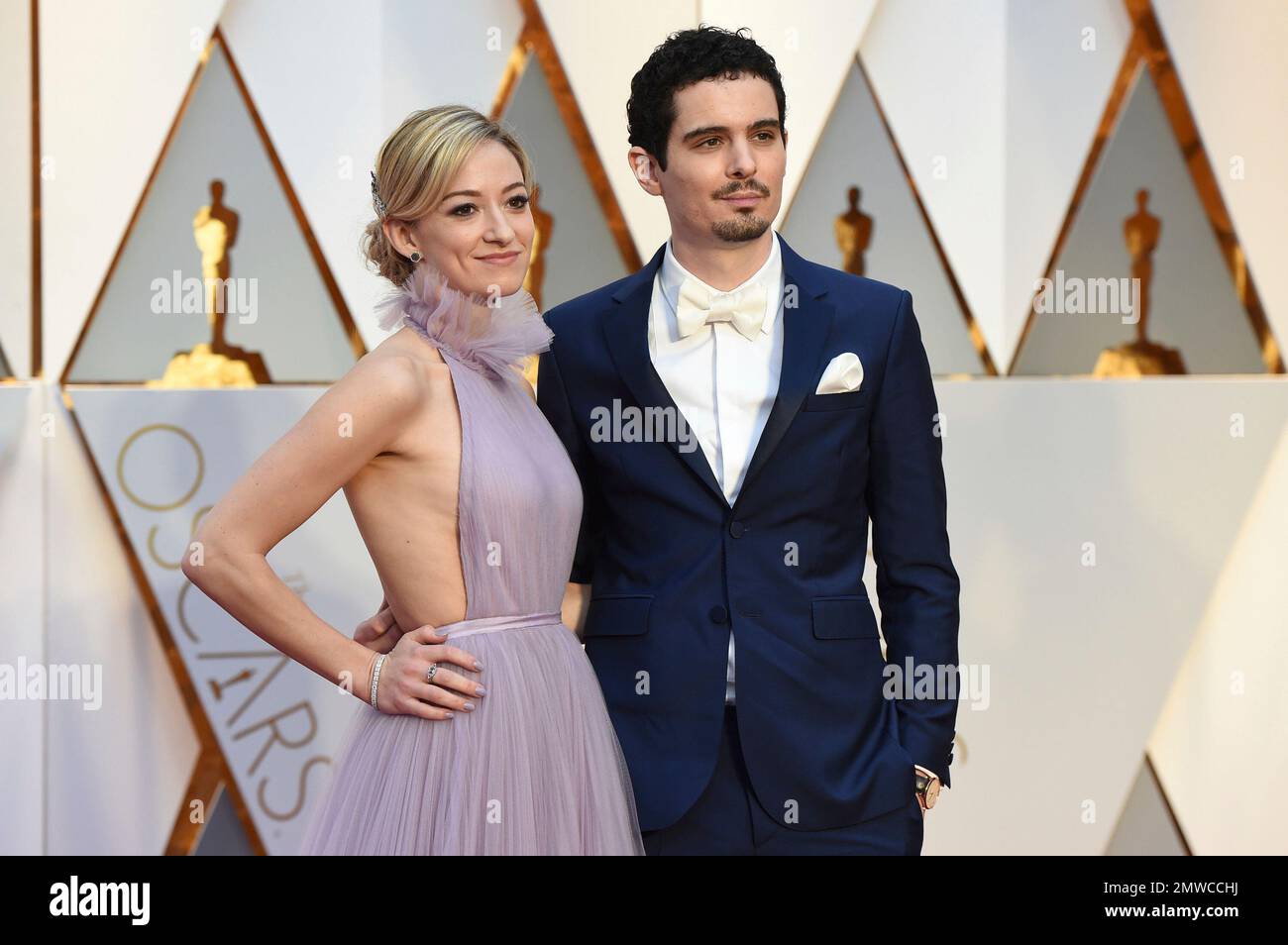 Olivia Hamilton, left, and Damien Chazelle arrive at the Oscars on ...