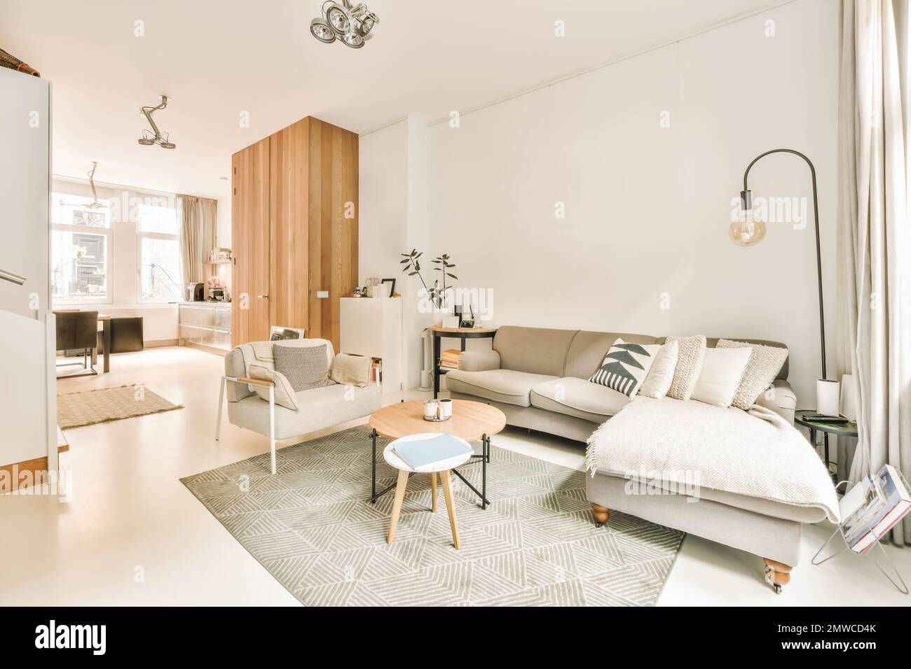 a living room with white walls and wood paneled panels on the wall ...