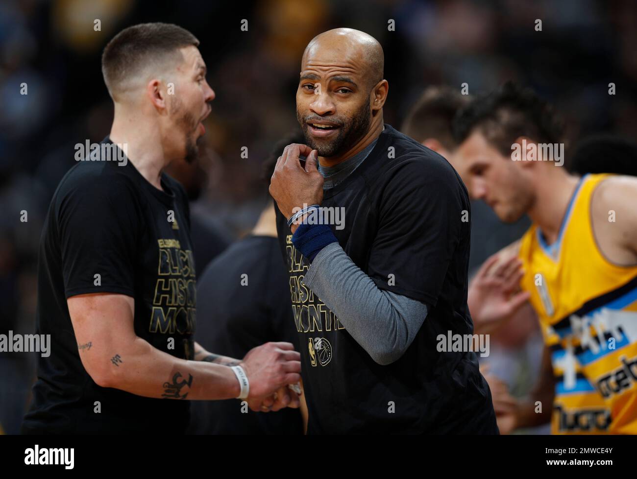 Denver Nuggets guard Mike Miller, left, jokes with Memphis Grizzlies ...