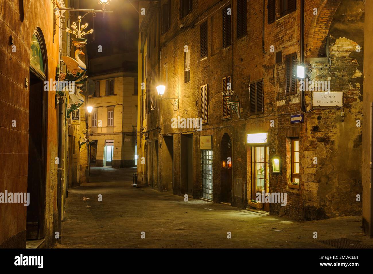 Night shot of narrow alleyway Via delle Terme in historic centre of ...