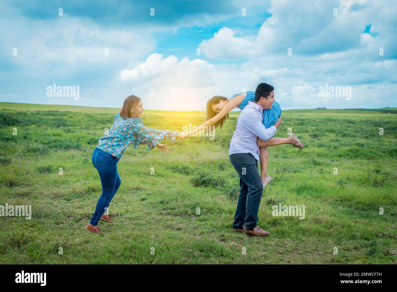 Boyfriend carrying his girlfriend on his back, three friends playing in ...