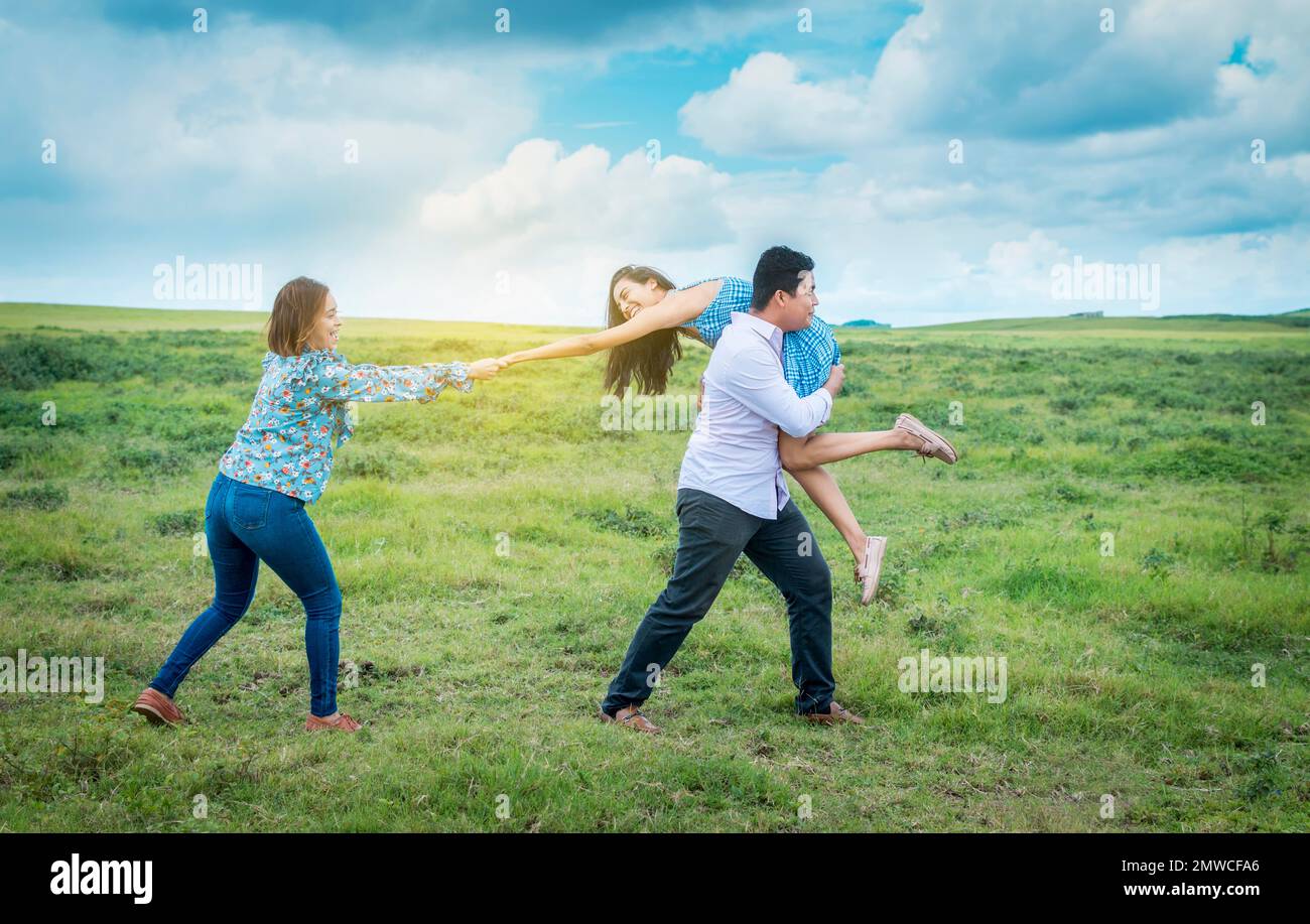 Boyfriend carrying his girlfriend on his back, three friends playing in ...
