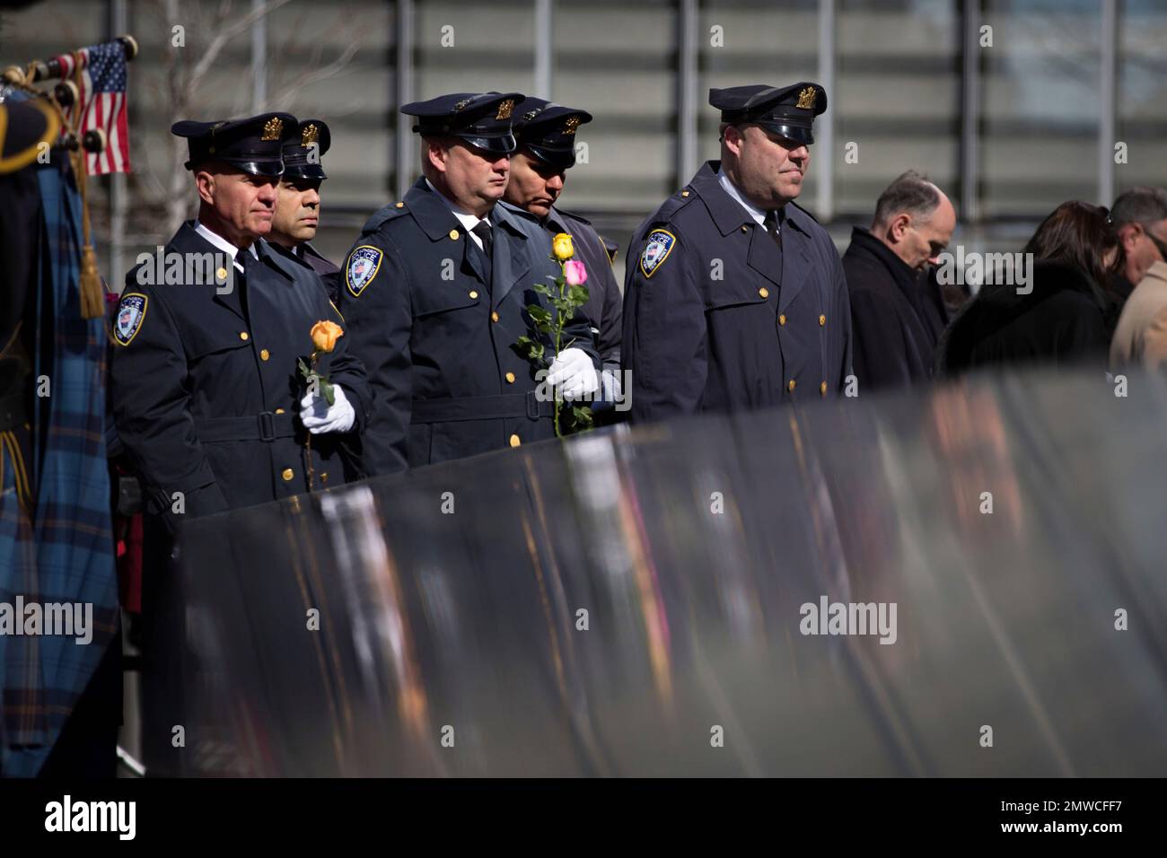 Port Authority officers hold roses during a ceremony to commemorate the ...