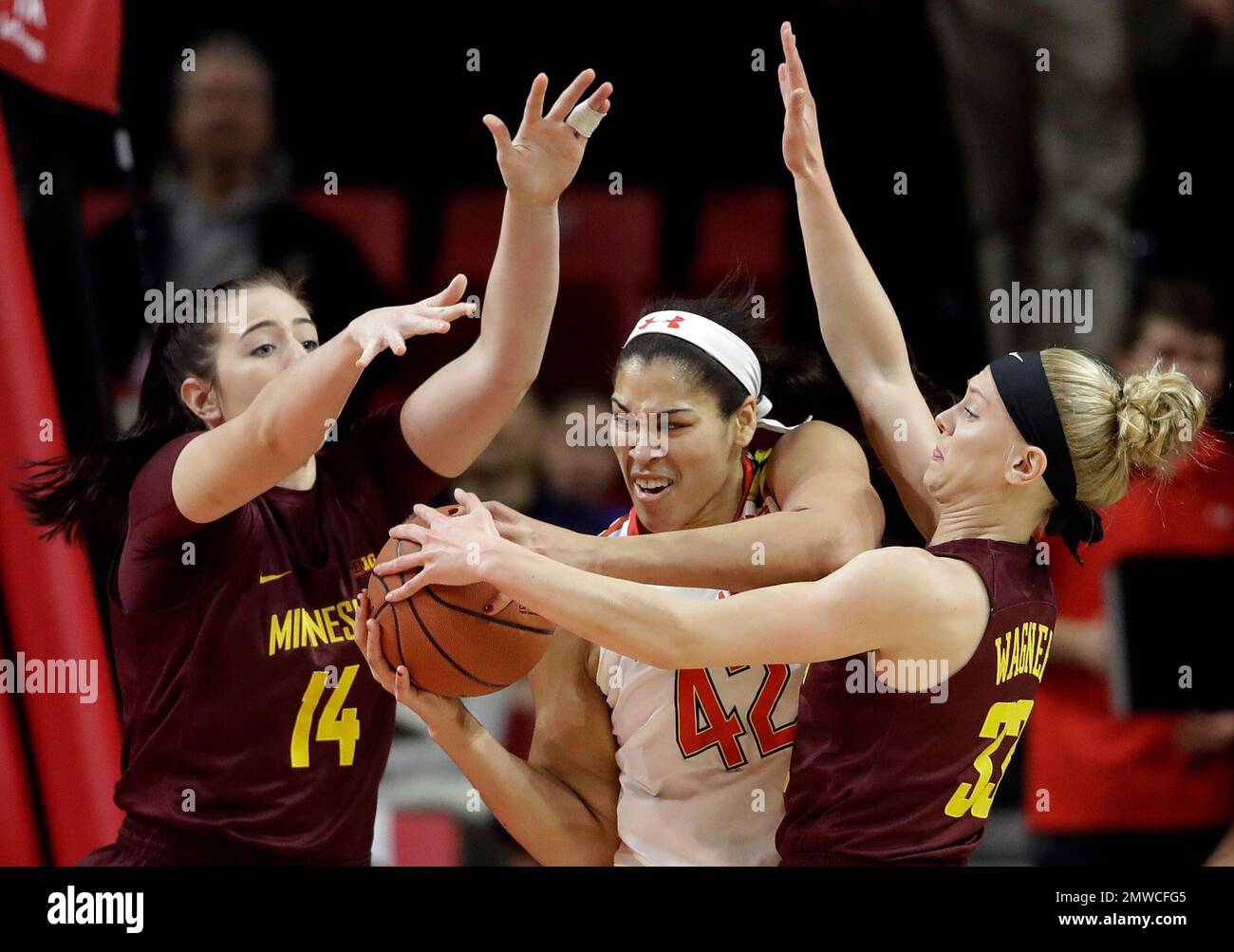 Maryland center Brionna Jones, center, drives between Minnesota center ...