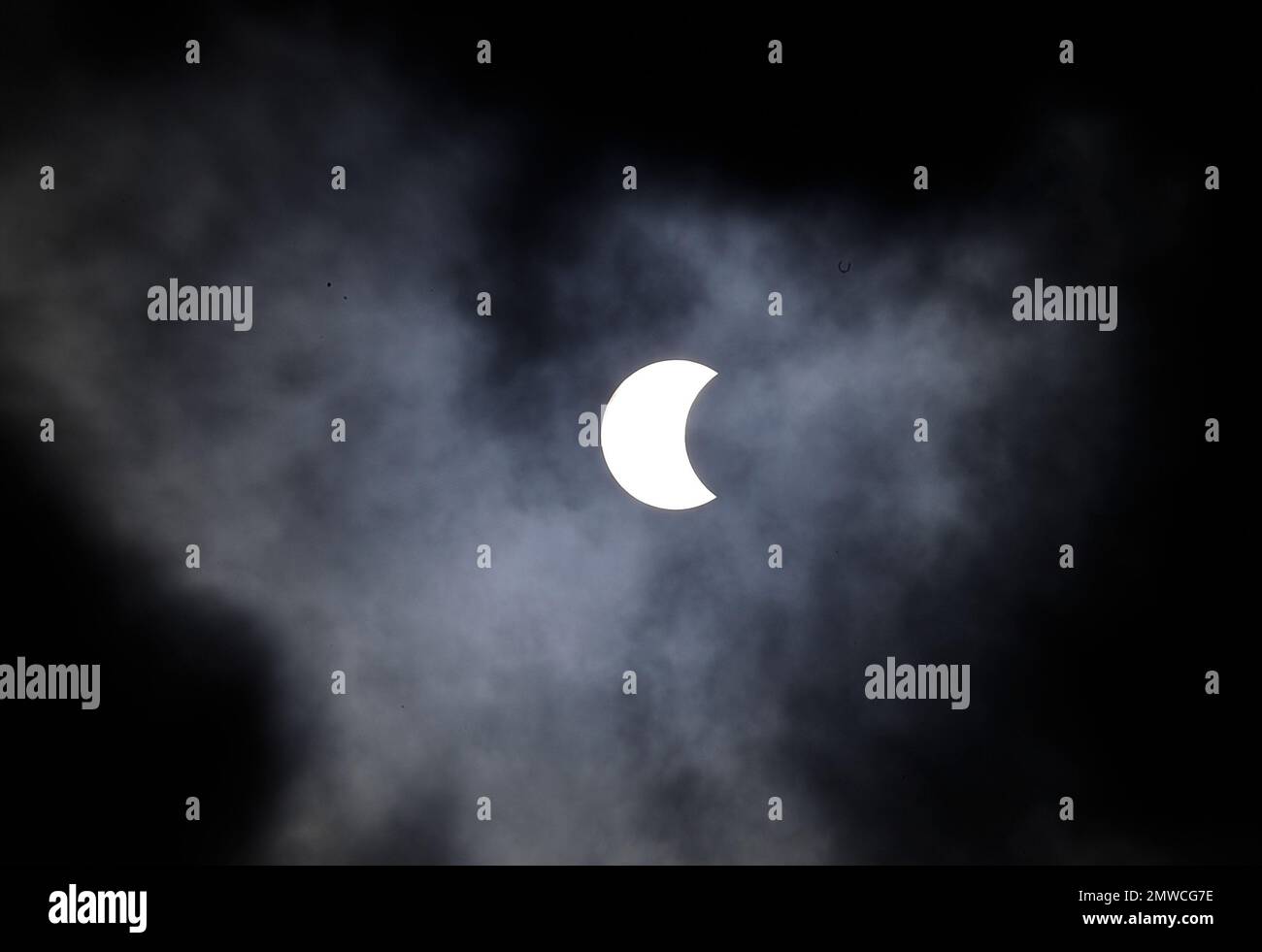 The moon passes in front of the sun, creating a solar eclipse visible ...