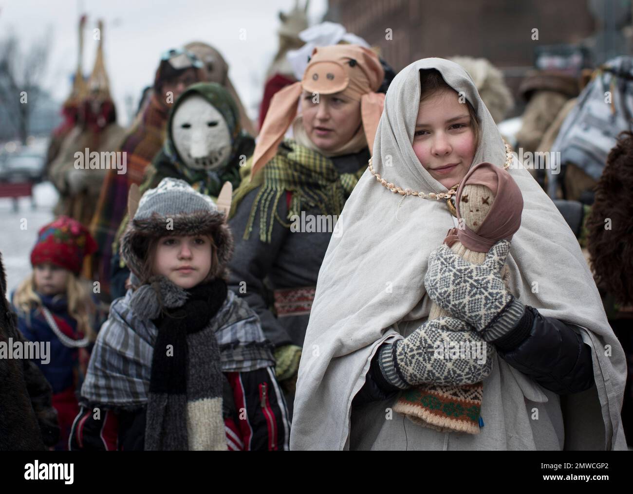 A girl wearing a carnival mask poses for a photo during the ...