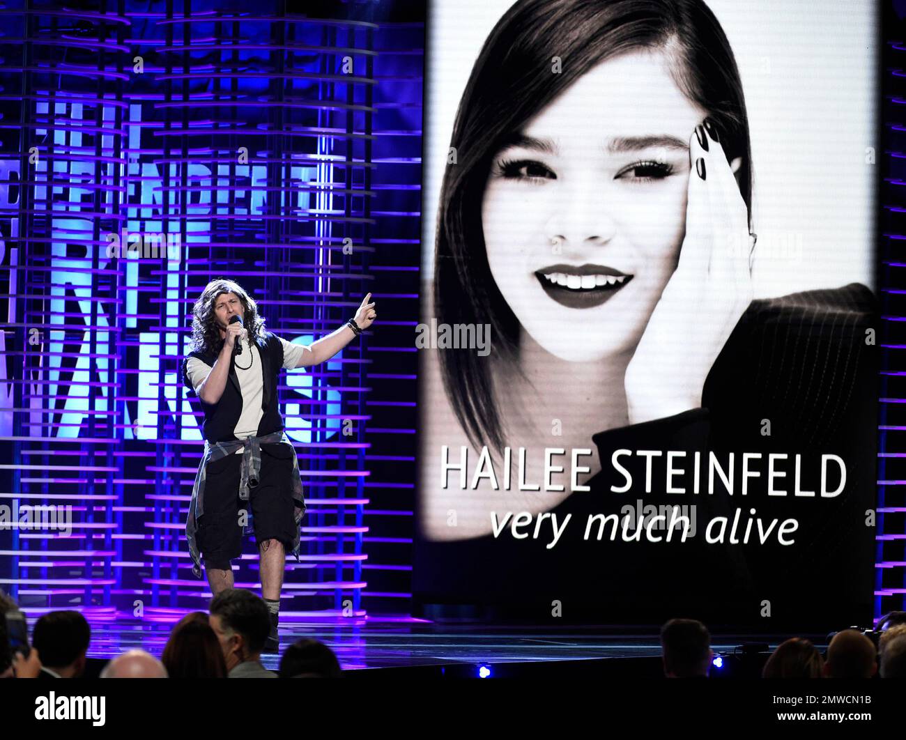 Andy Samberg performs while Hailee Steinfeld is seen on screen at the ...