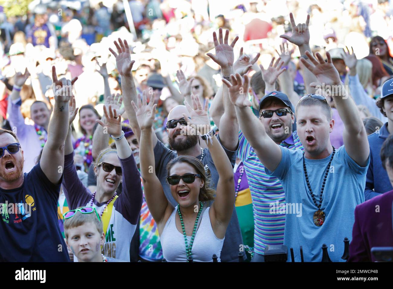 People cheer as Cowboy Mouth performs for the crowd on the front porch ...