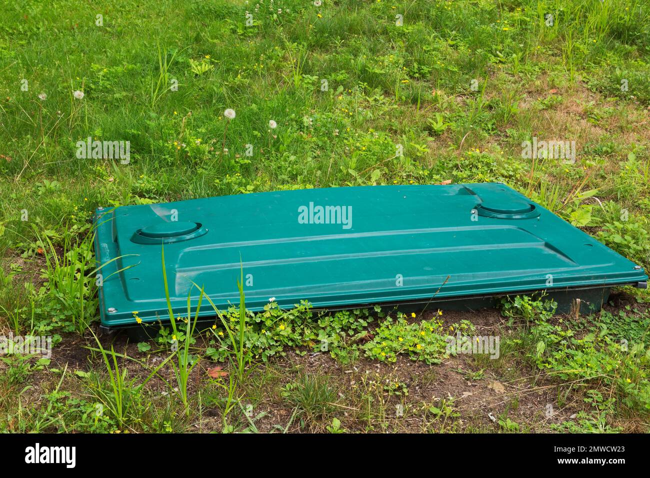 Septic tank cover in residential backyard, Quebec, Canada Stock Photo ...